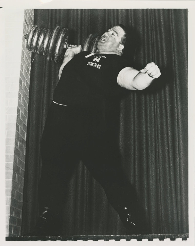 Photo of Paul Anderson lifting a large dumbell | Rogue Canada