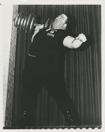 Photo of Paul Anderson lifting a large dumbell | Rogue Canada